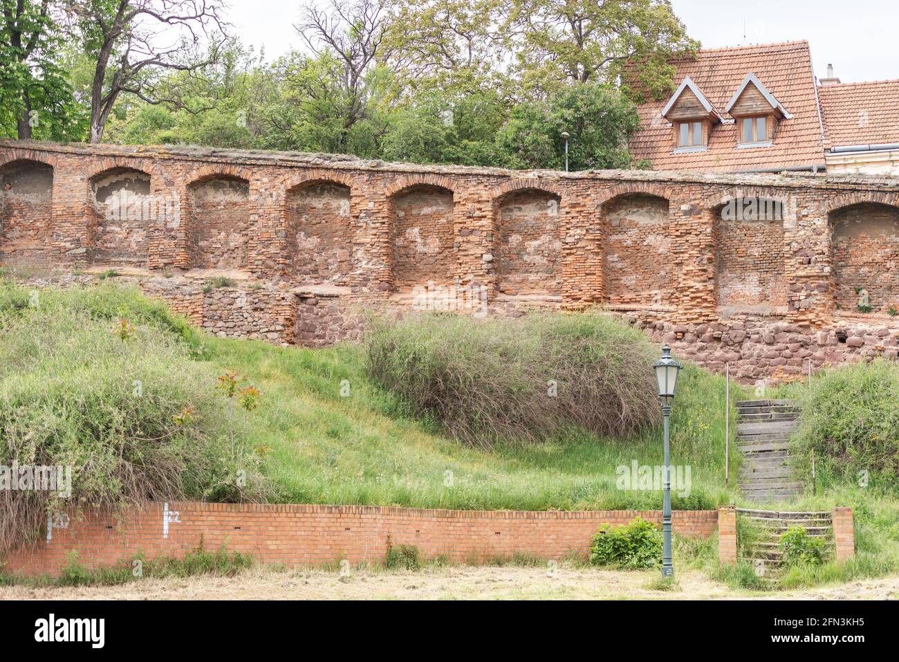 Old defensive wall in Brno. A very ancient dilapidated brick wall and ...