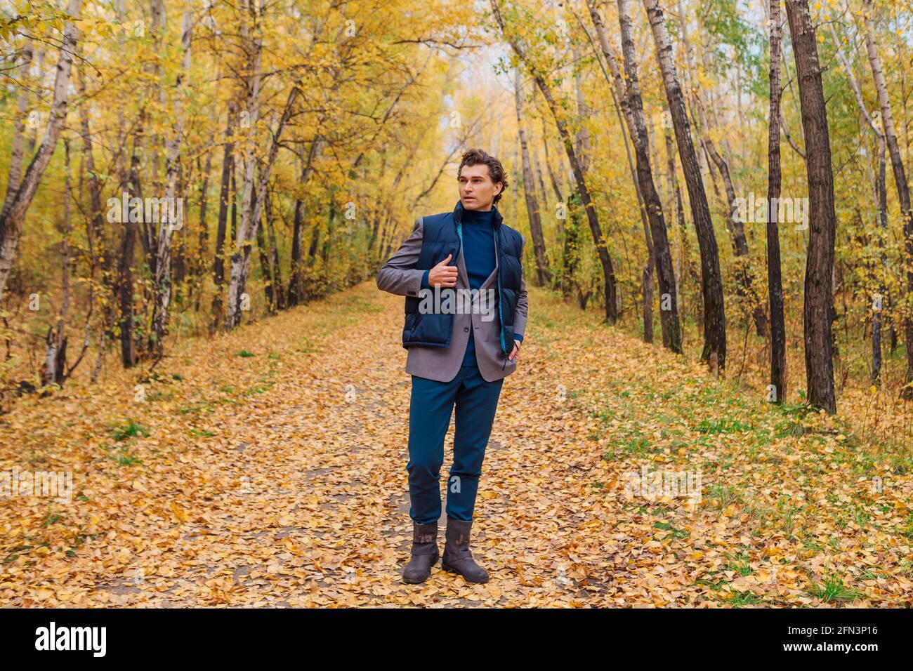 Tall handsome man walking in the autumn alley Stock Photo - Alamy