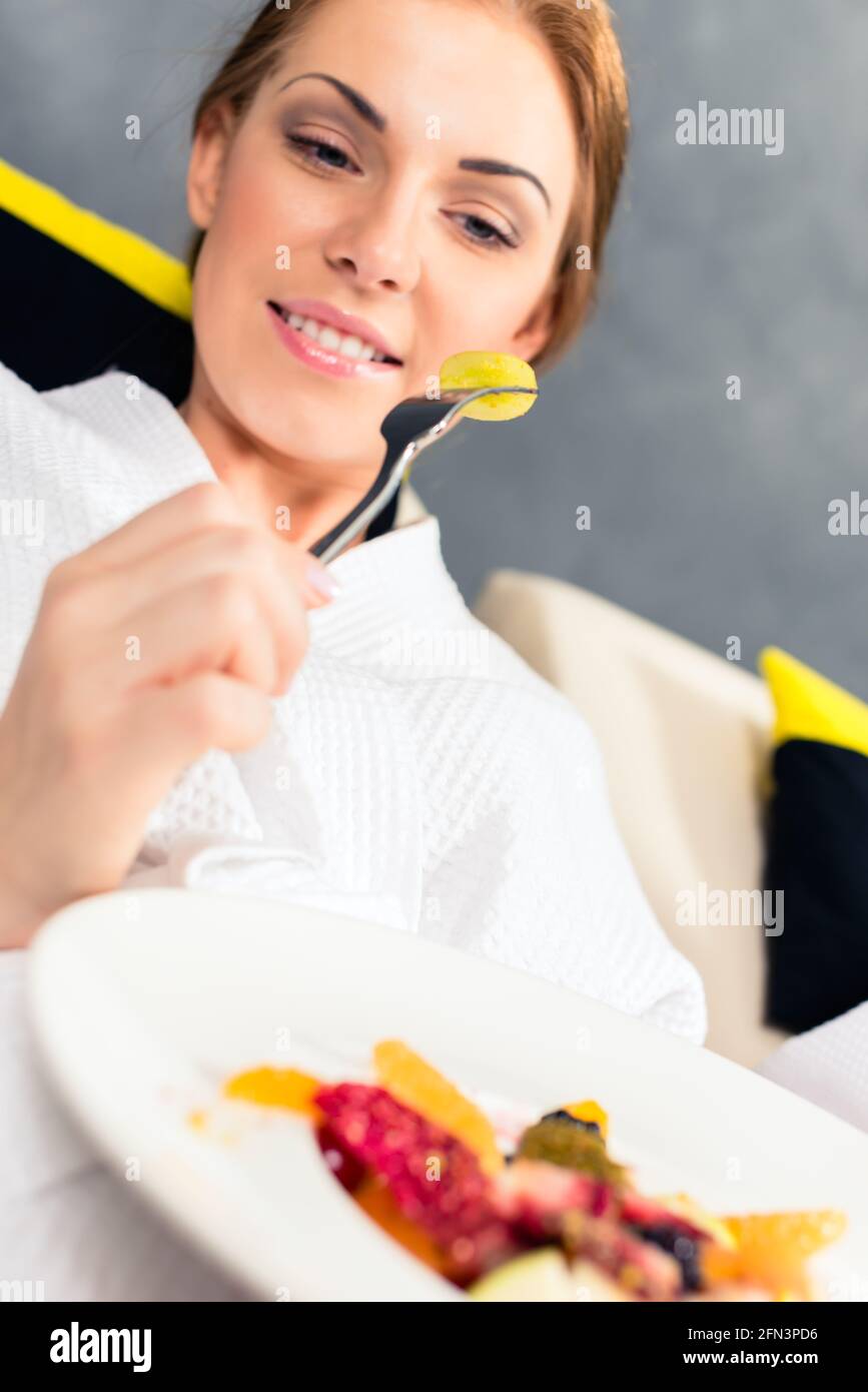 Happy young woman eating healthy food in breakfast Stock Photo - Alamy