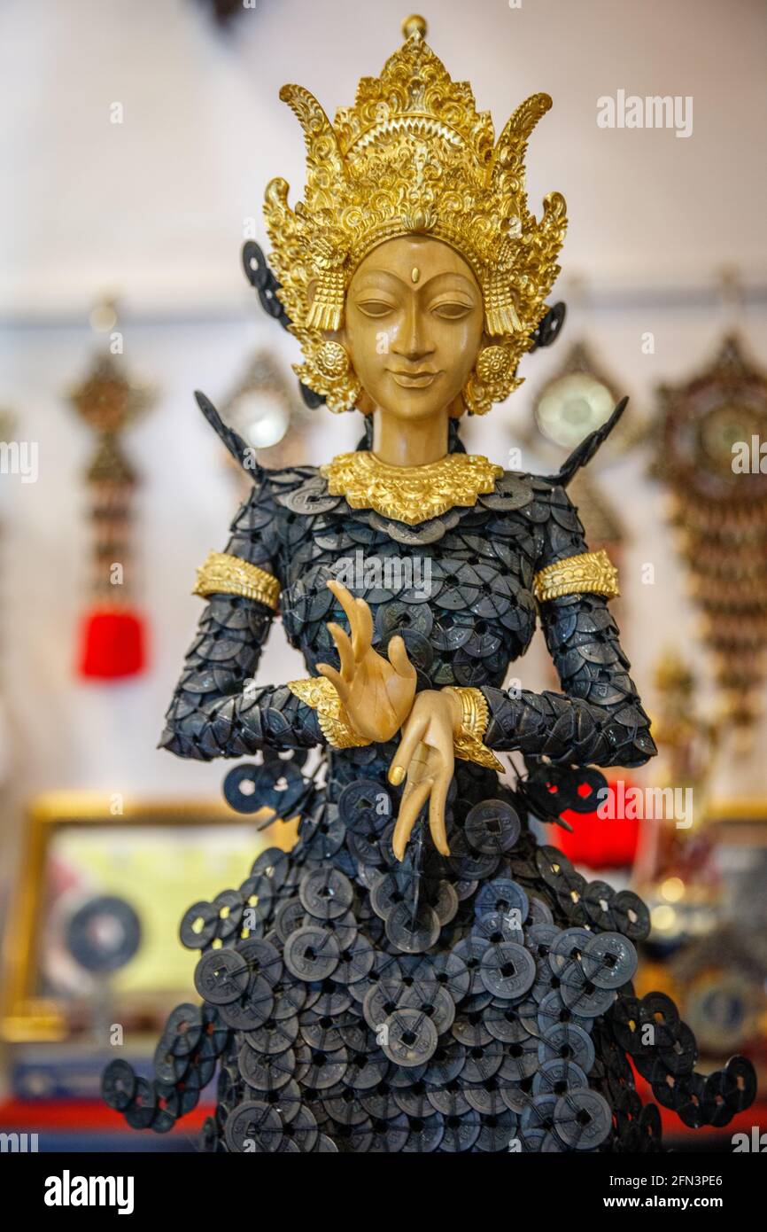 Statue of Balinese traditional dancer made of hollowed coins (kepeng ...