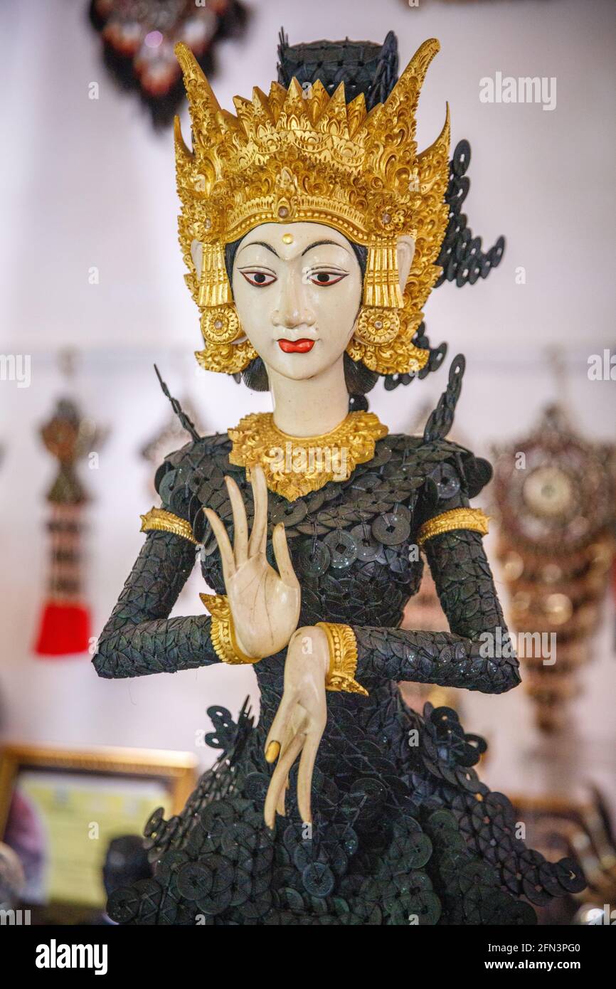 Statue of Balinese traditional dancer made of hollowed coins (kepeng ...