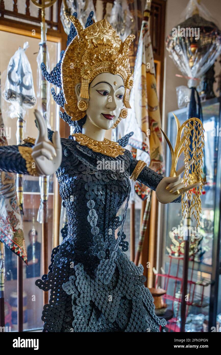Statue of Balinese traditional dancer made of hollowed coins (kepeng ...