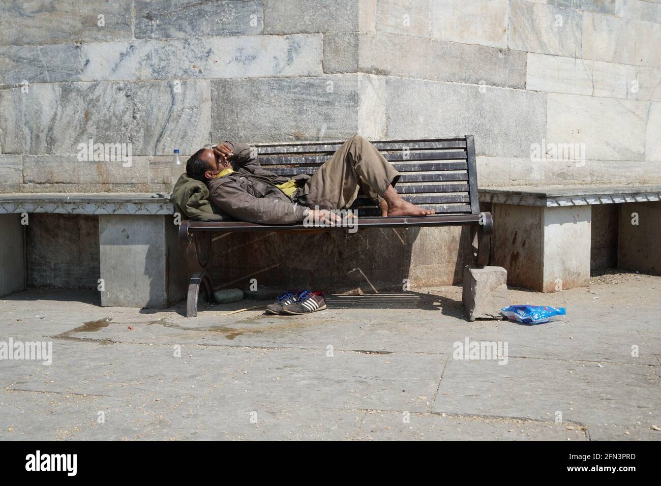 Homelessness person sleeping on bench hi-res stock photography and ...