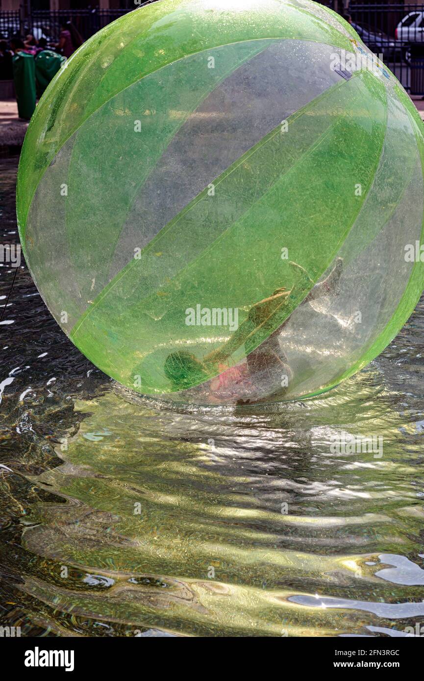 Children playing on an inflatable water waking ride (Zorb ball) at the ...