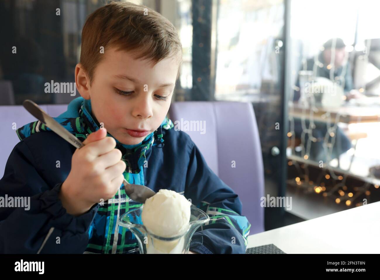 Child eating ice cream in a restaurant Stock Photo - Alamy