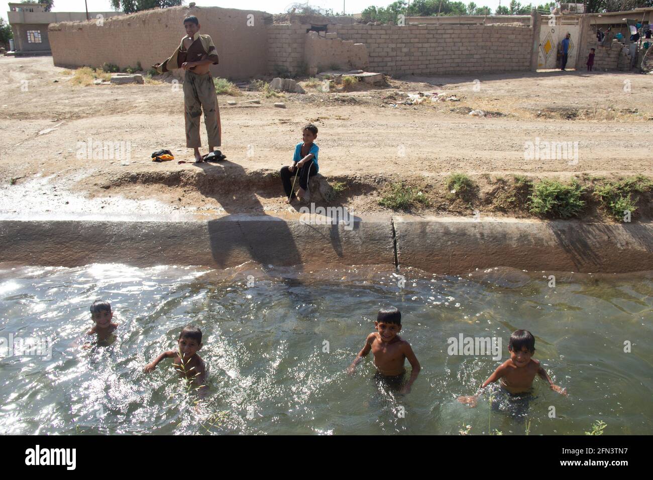 Boys swimming to cool off in the summer heat during the 2016-2017 Mosul ...