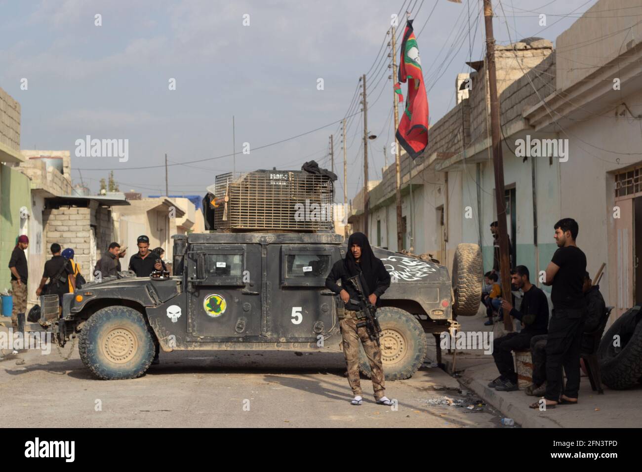 Iraqi Special Forces soldiers with a Humvee guard a street during the ...
