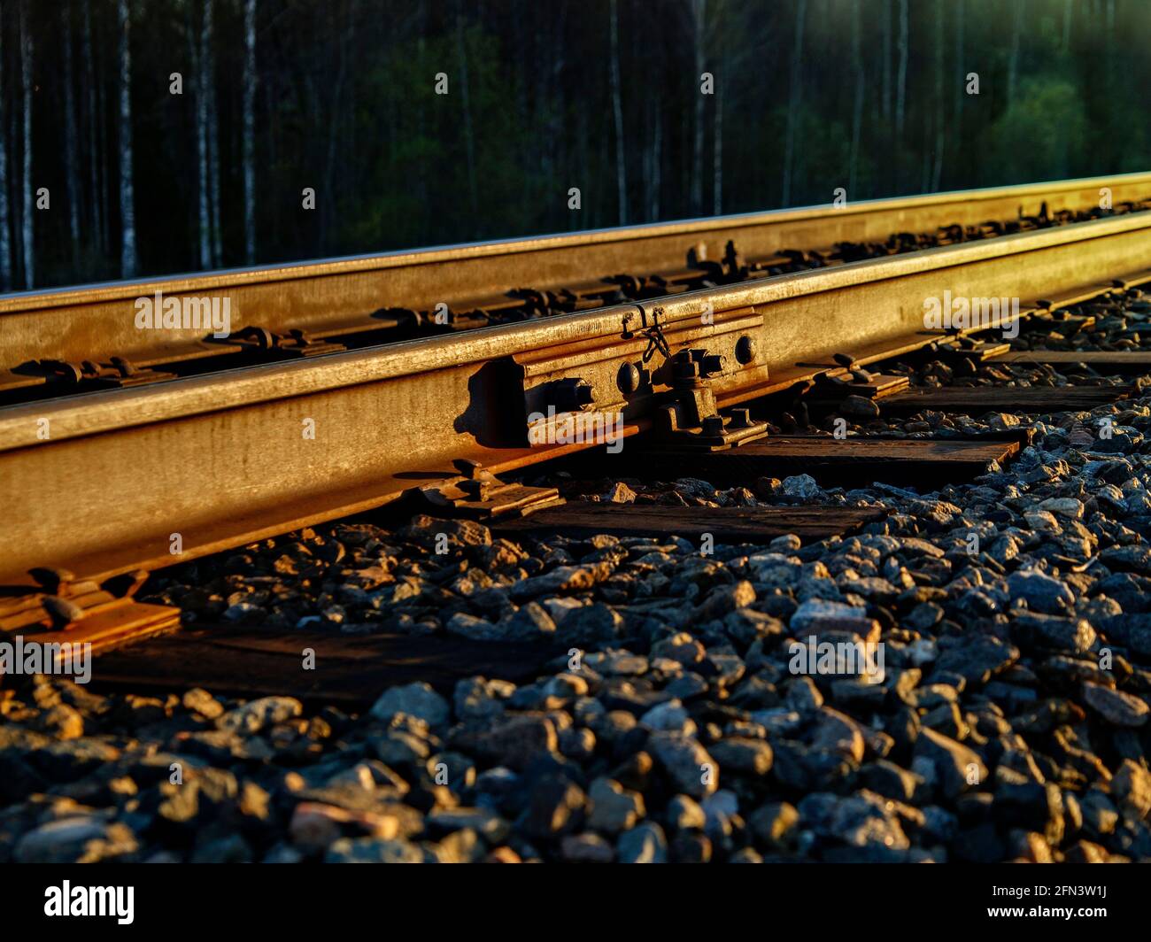 Junction of railway rails is illuminated by setting sun Stock Photo - Alamy