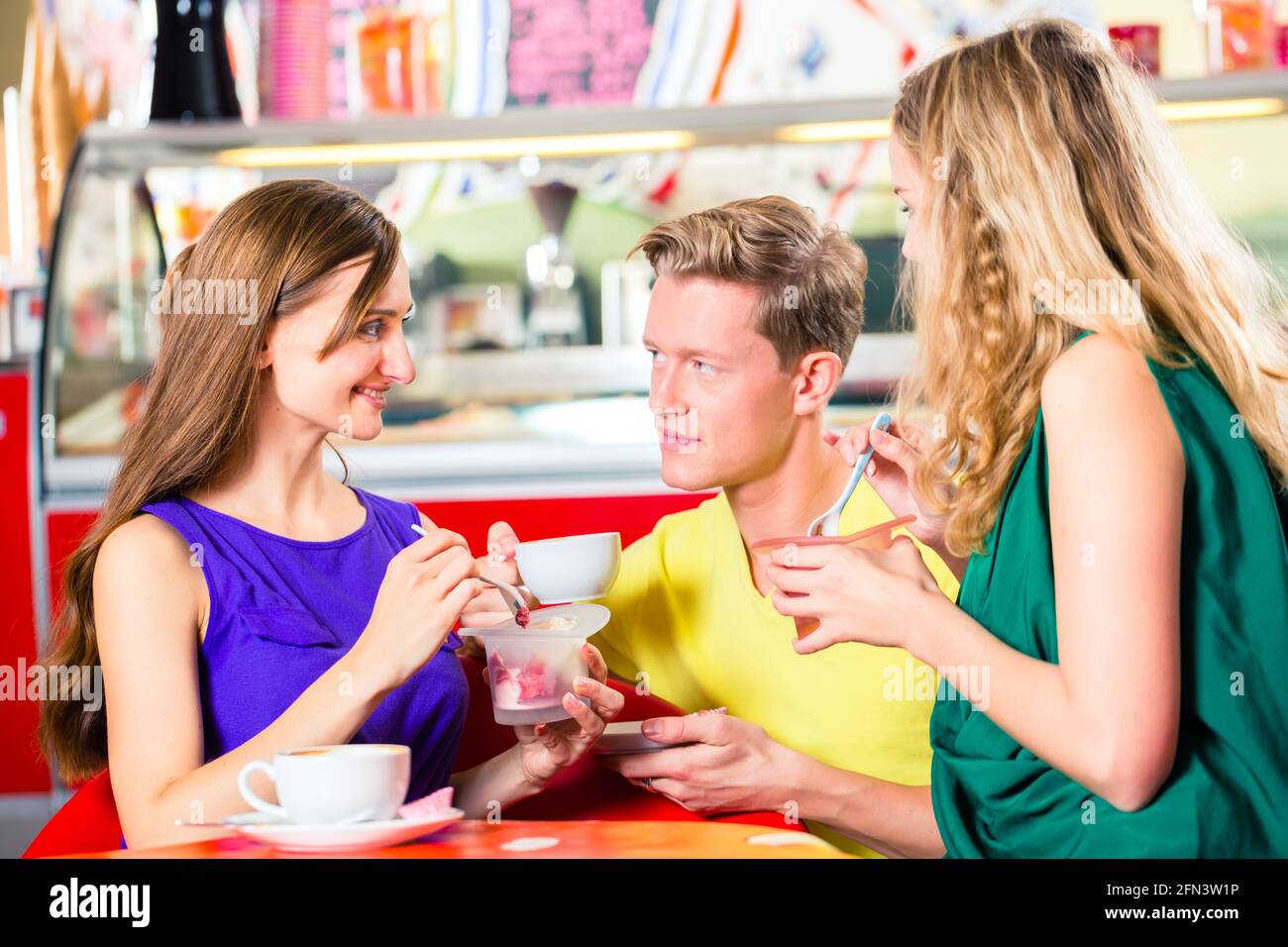 Friends meeting in ice cream parlor or cafe with cappuccino and ice ...