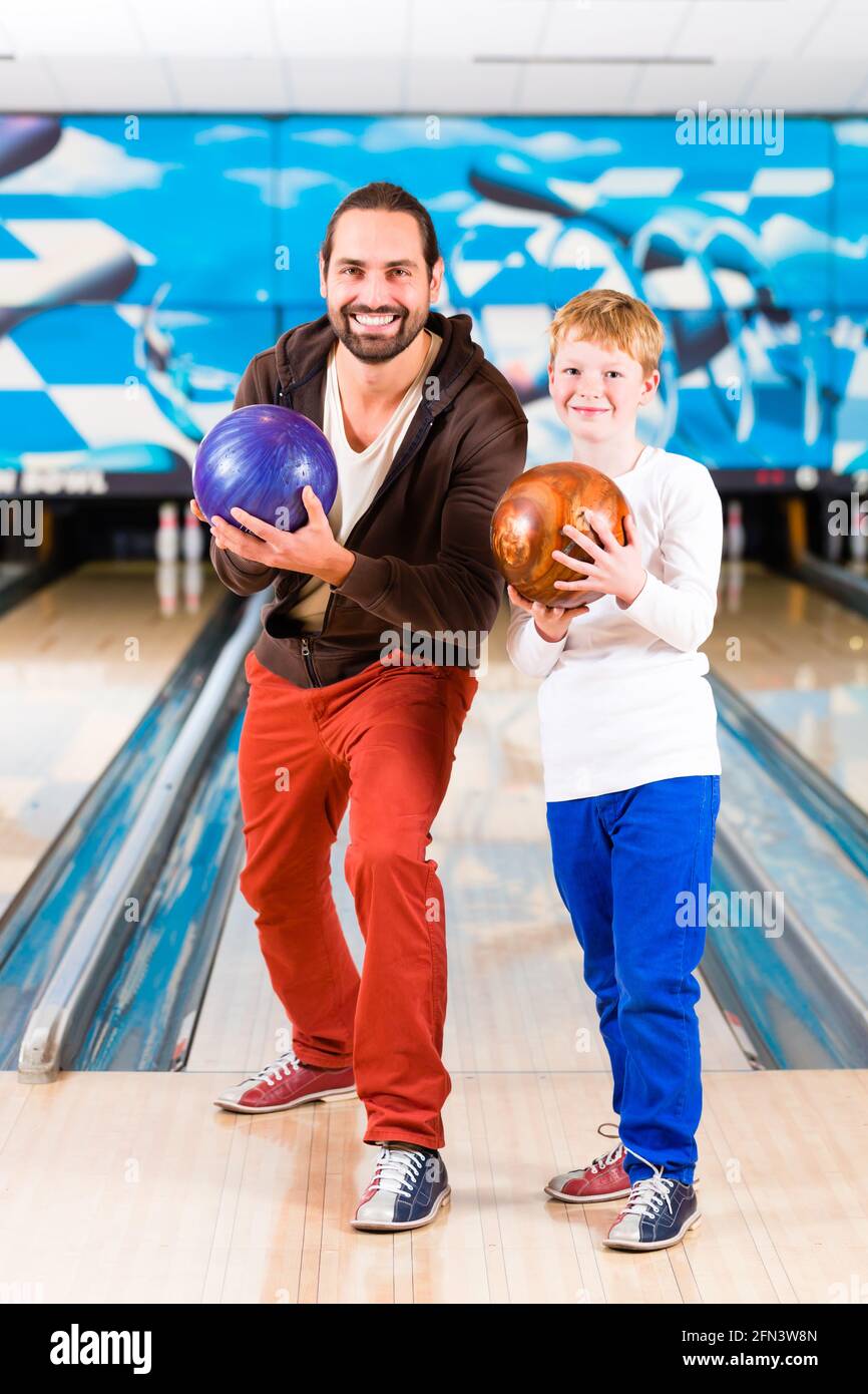 Father and son playing in bowling center Stock Photo - Alamy
