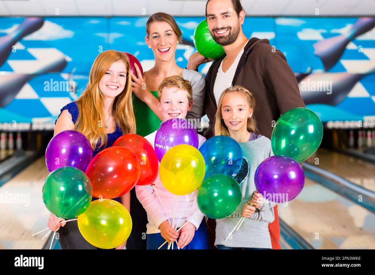 Family and friends celebrating birthday at bowling center Stock Photo ...