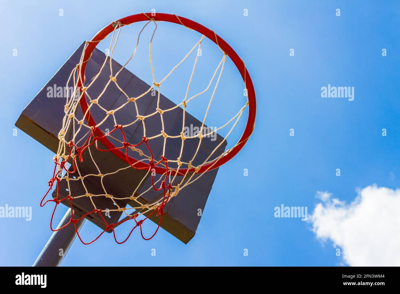 Outdoor basketball hoop with blue sky and clouds background Stock Photo ...