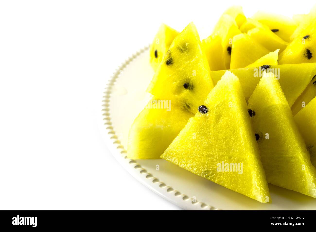 Slices of yellow watermelon on white disk on white background Stock ...
