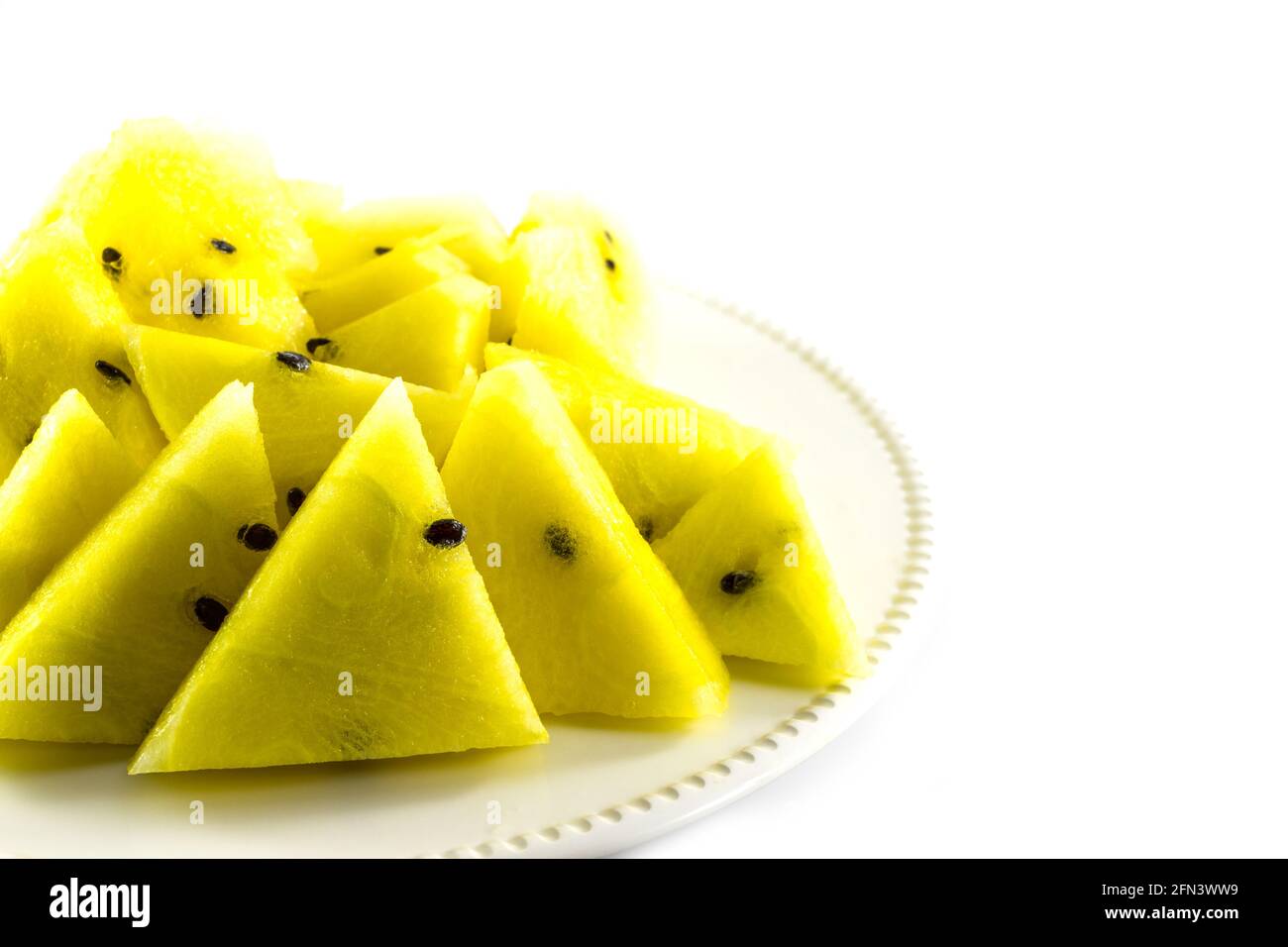 Slices of yellow watermelon on white disk on white background Stock ...