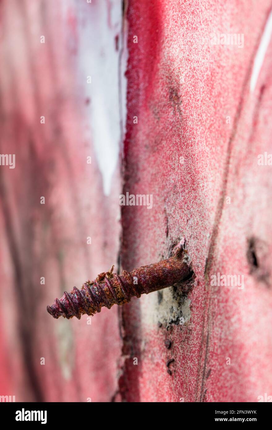 Exposed nail in old exterior wall. (Urban decay series Stock Photo - Alamy
