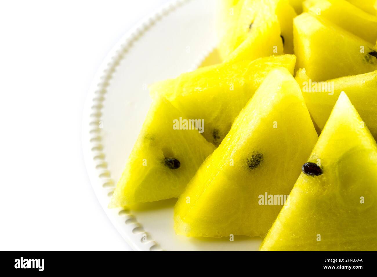 Slices of yellow watermelon on white disk on white background Stock ...