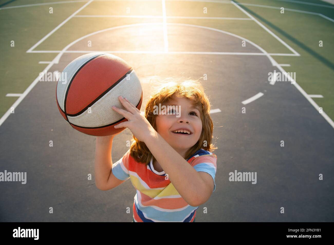 Kid playing basketball with basket ball laughing and having fun, Top ...