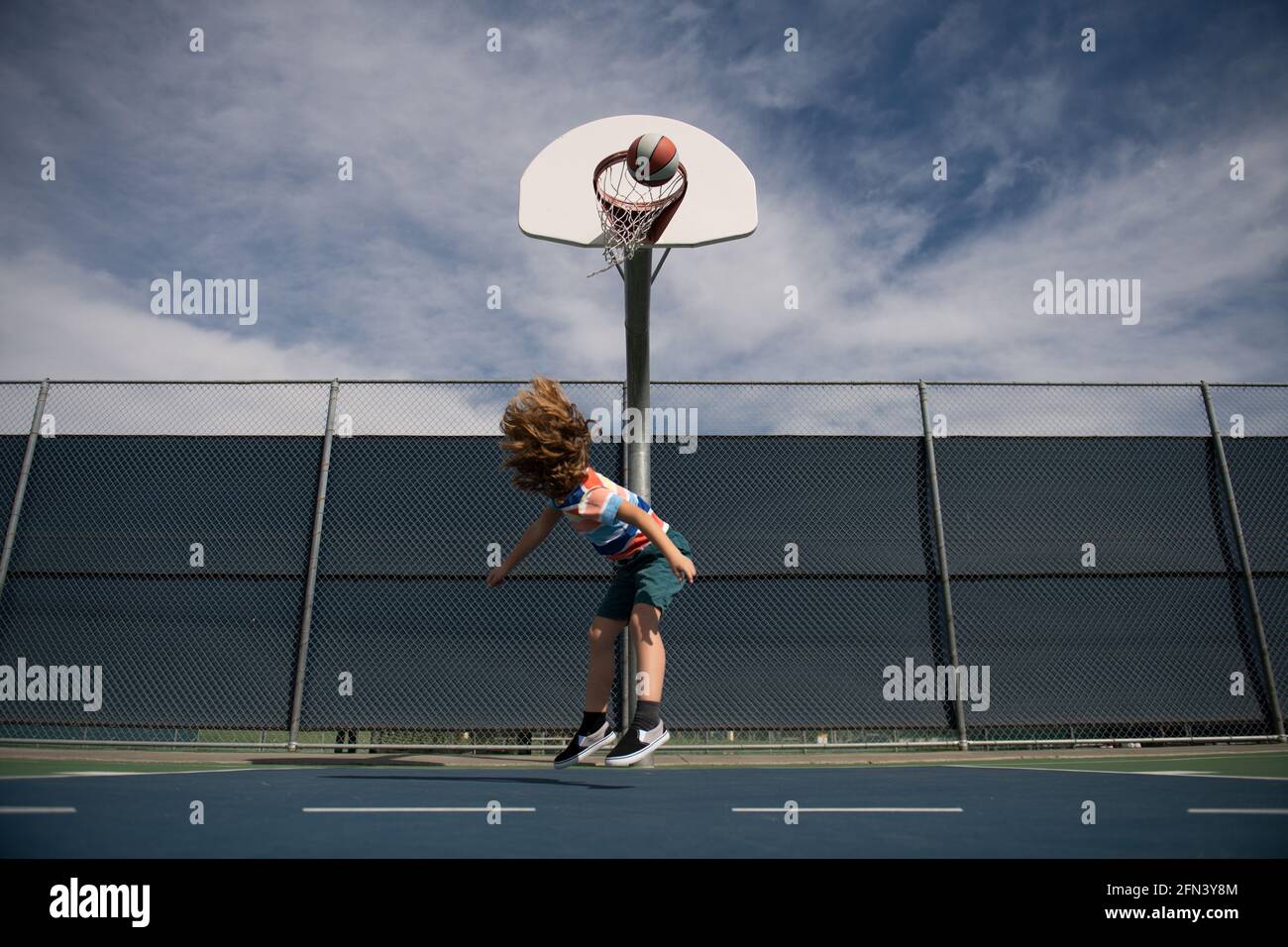 Happy little boy kid playing basketball on playground Stock Photo - Alamy