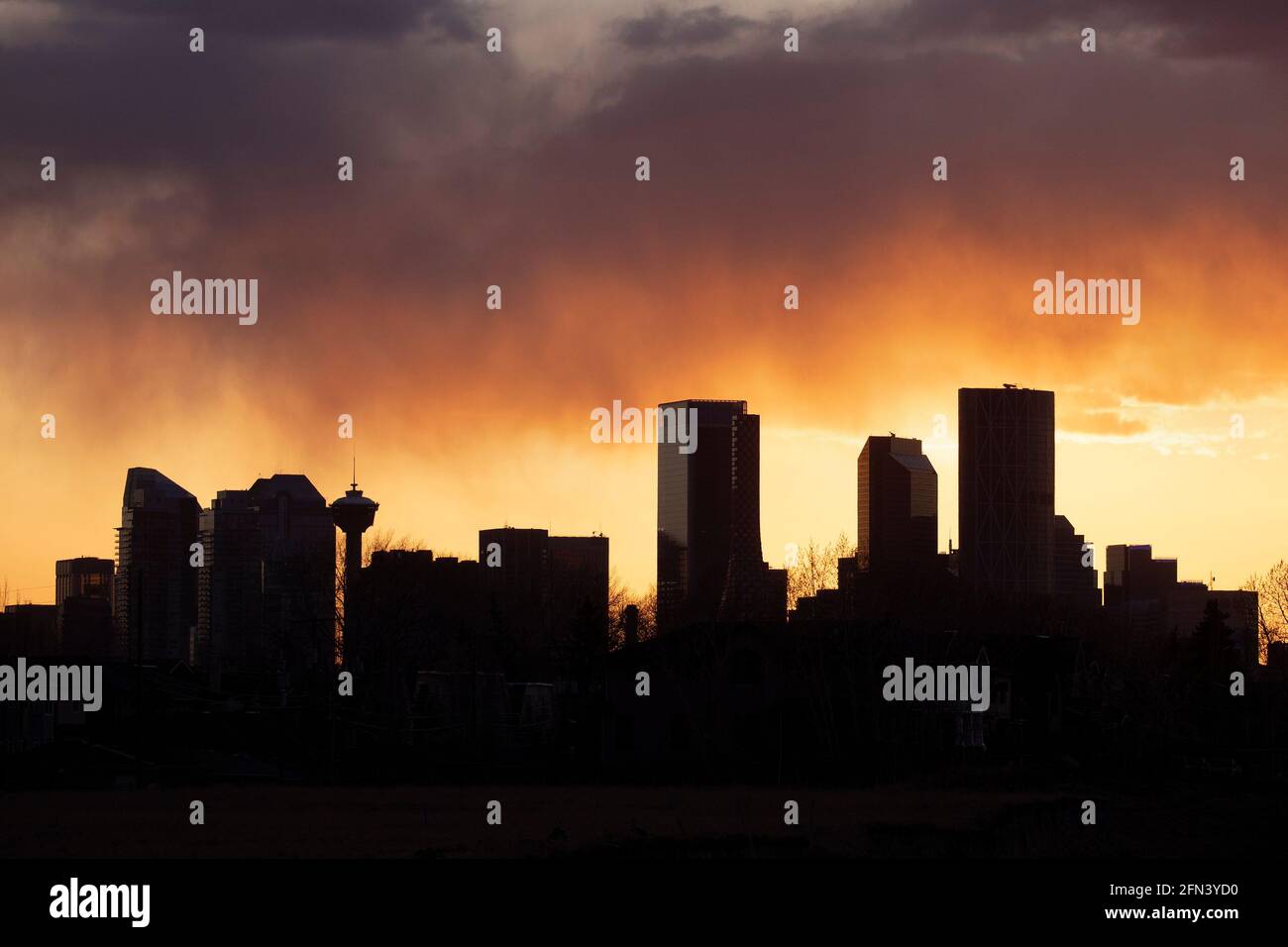 Yellow, orange and purple sunset sky over downtown Calgary skyline ...