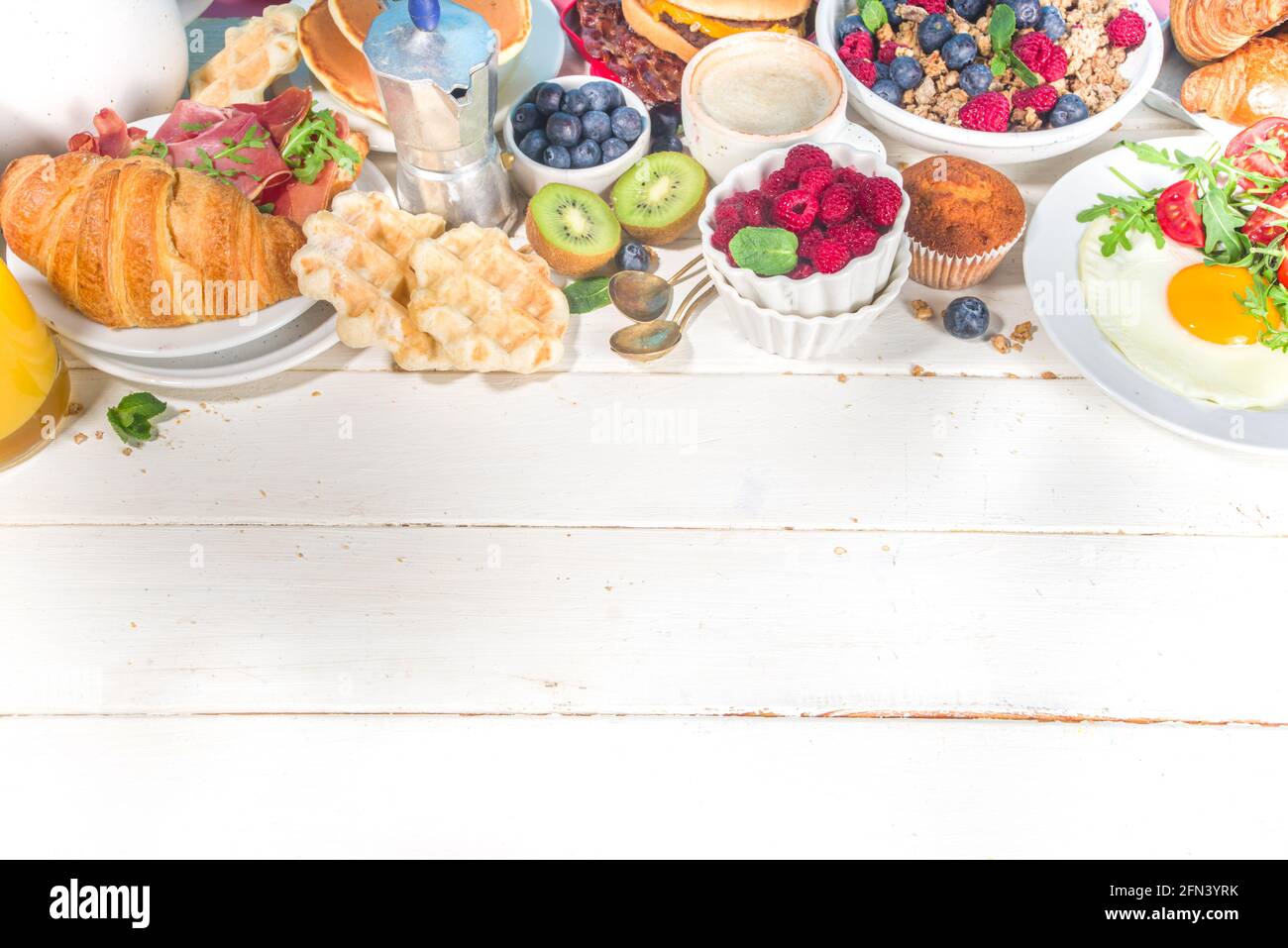 Various traditional breakfast food - fried eggs with bacon, muesli ...