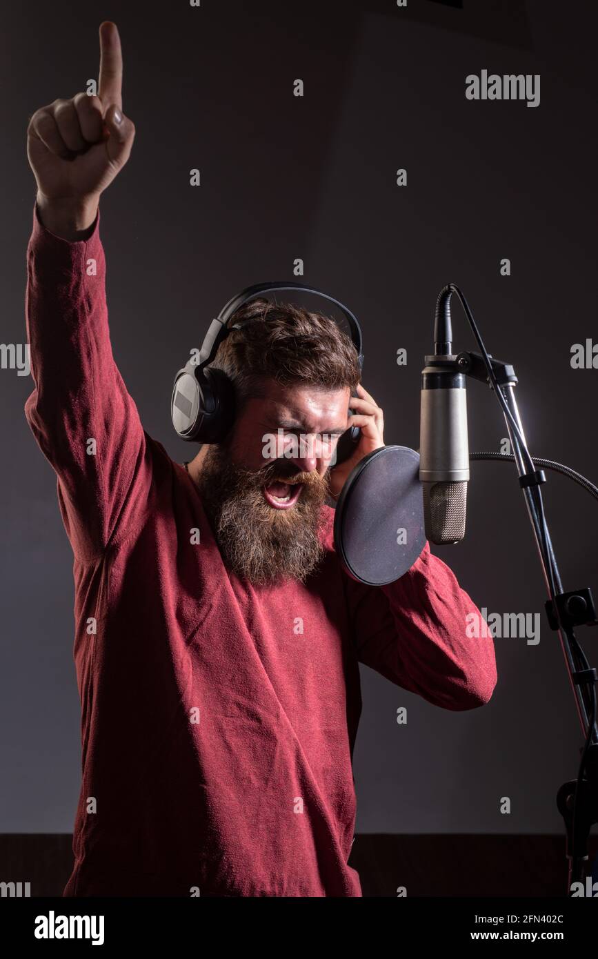 Handsome man in recording studio. Music performance vocal. Singer with ...