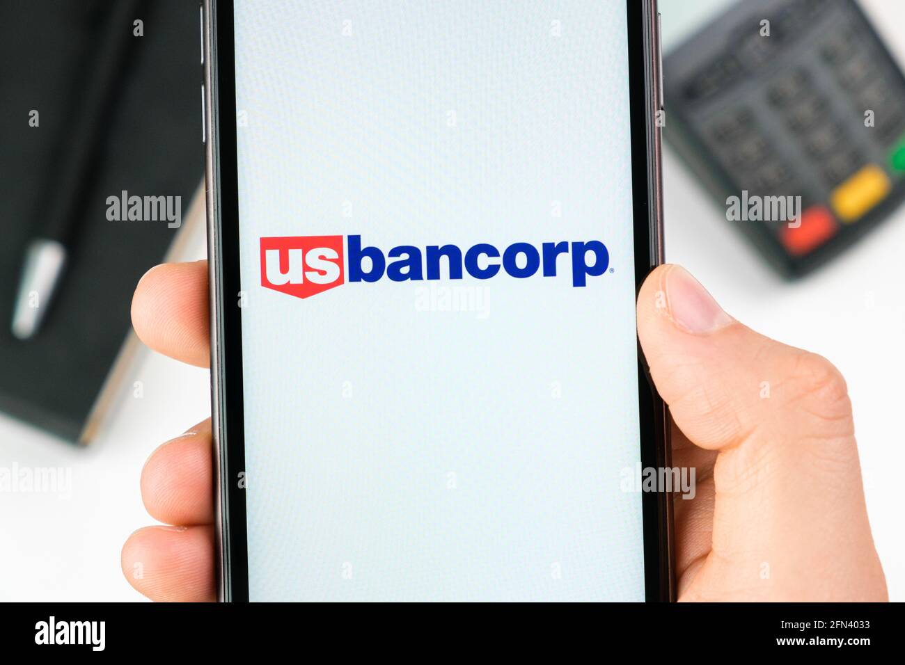 US bancorp bank logo on the smartphone screen in mans hand on the ...
