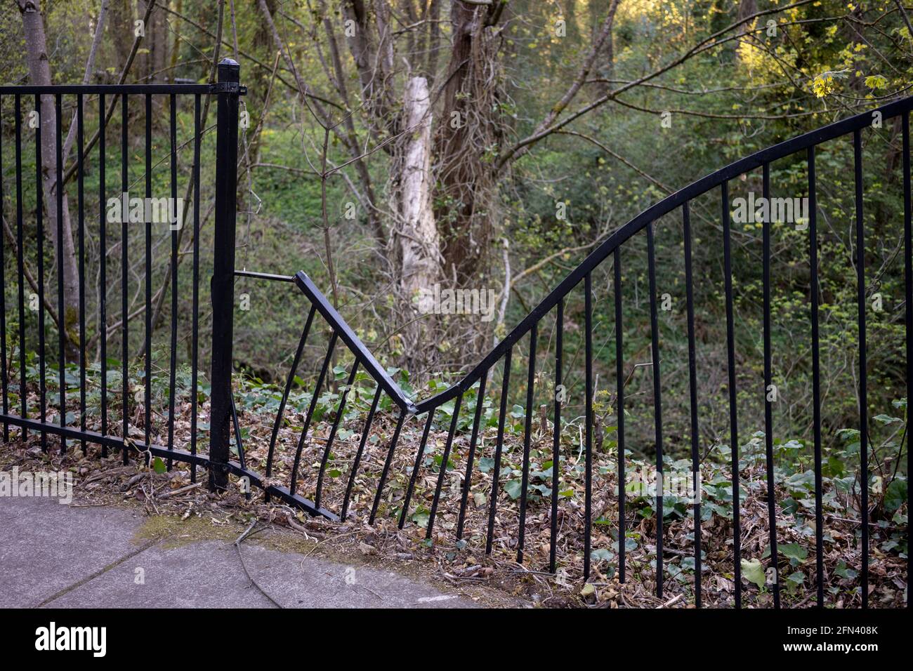 Railings damaged by a fallen tree during storm Stock Photo - Alamy