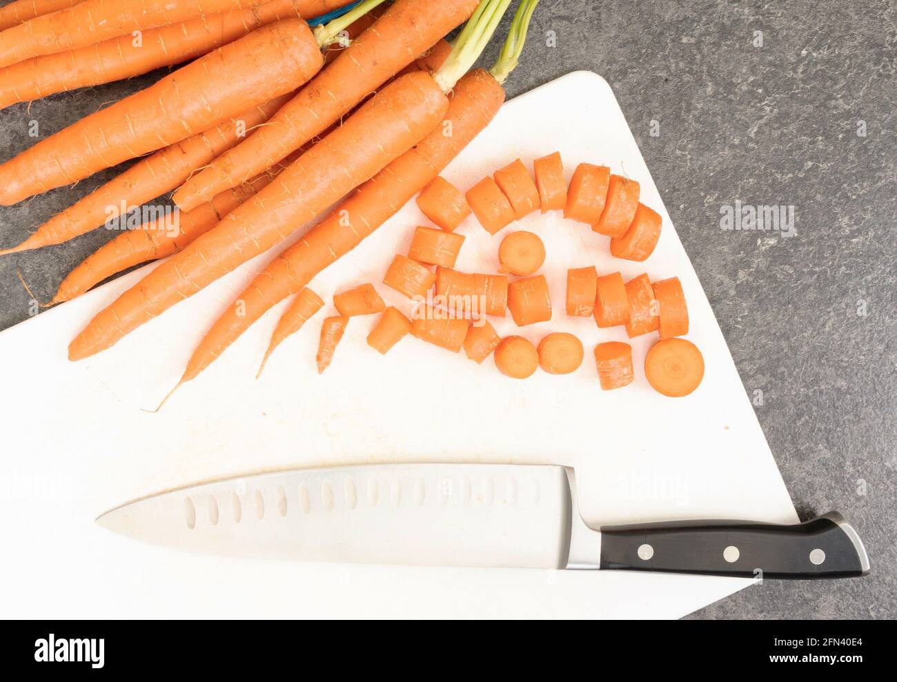 Cutting board with carrots and a sharp knife - Concept of food Stock ...