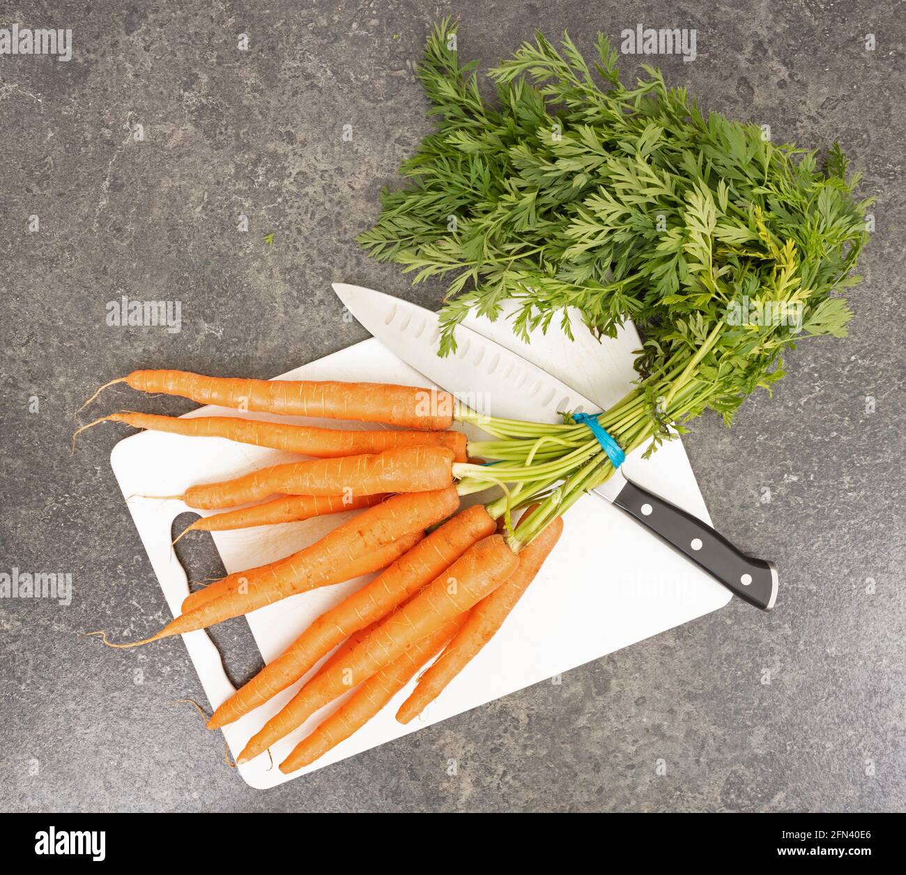 Cutting board with carrots and a sharp knife - Concept of food Stock ...
