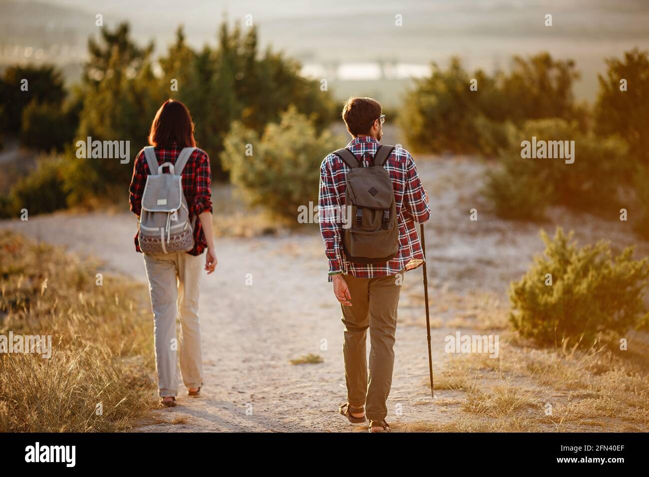 Portrait of happy young couple having fun on their hiking trip ...