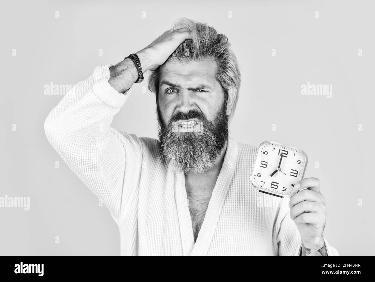 Too early. bedtime headache. Destroy the Clock. handsome angry man ...