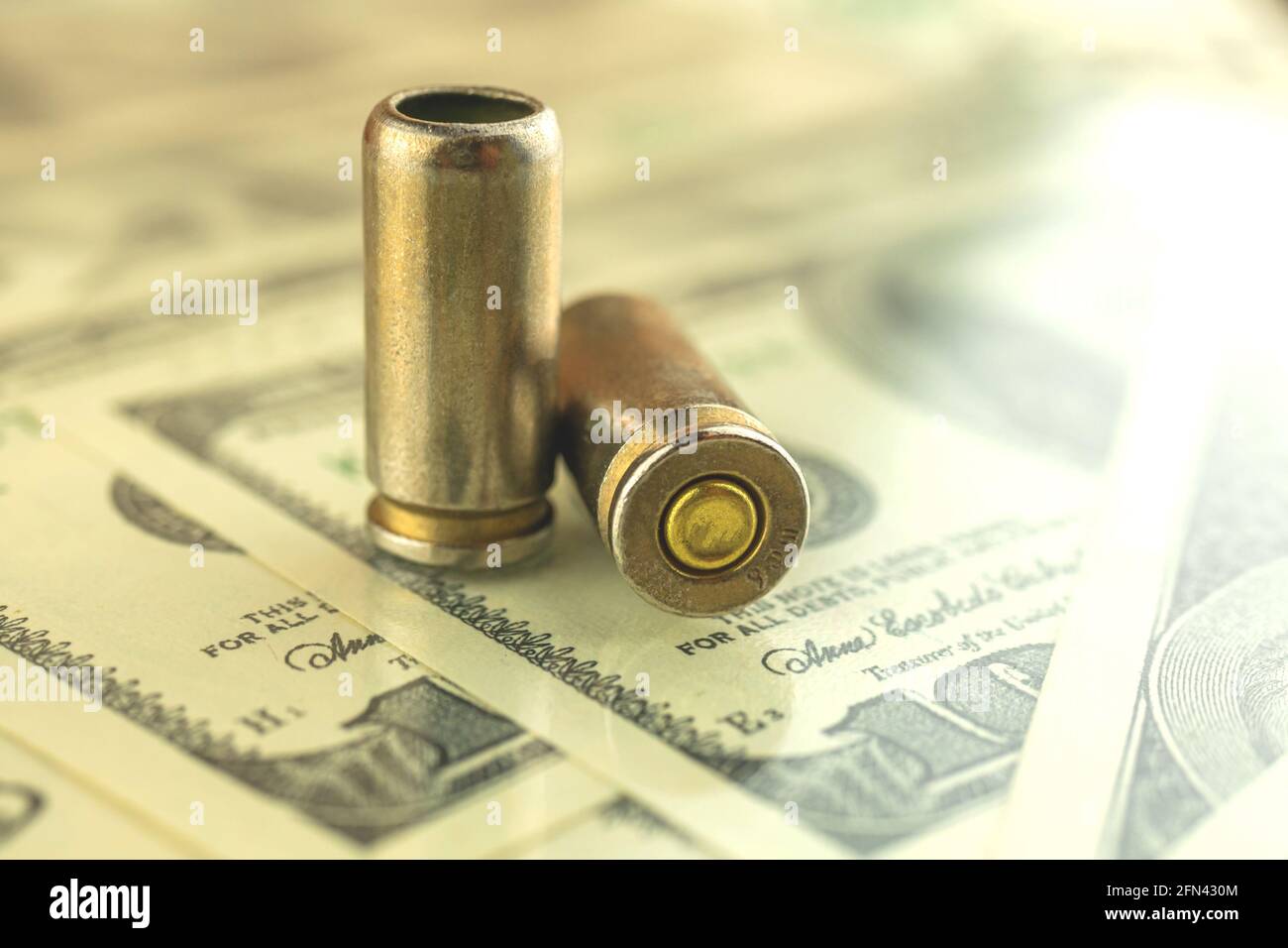 Criminal money background with dollar banknotes and bullet for gun, 9mm ...