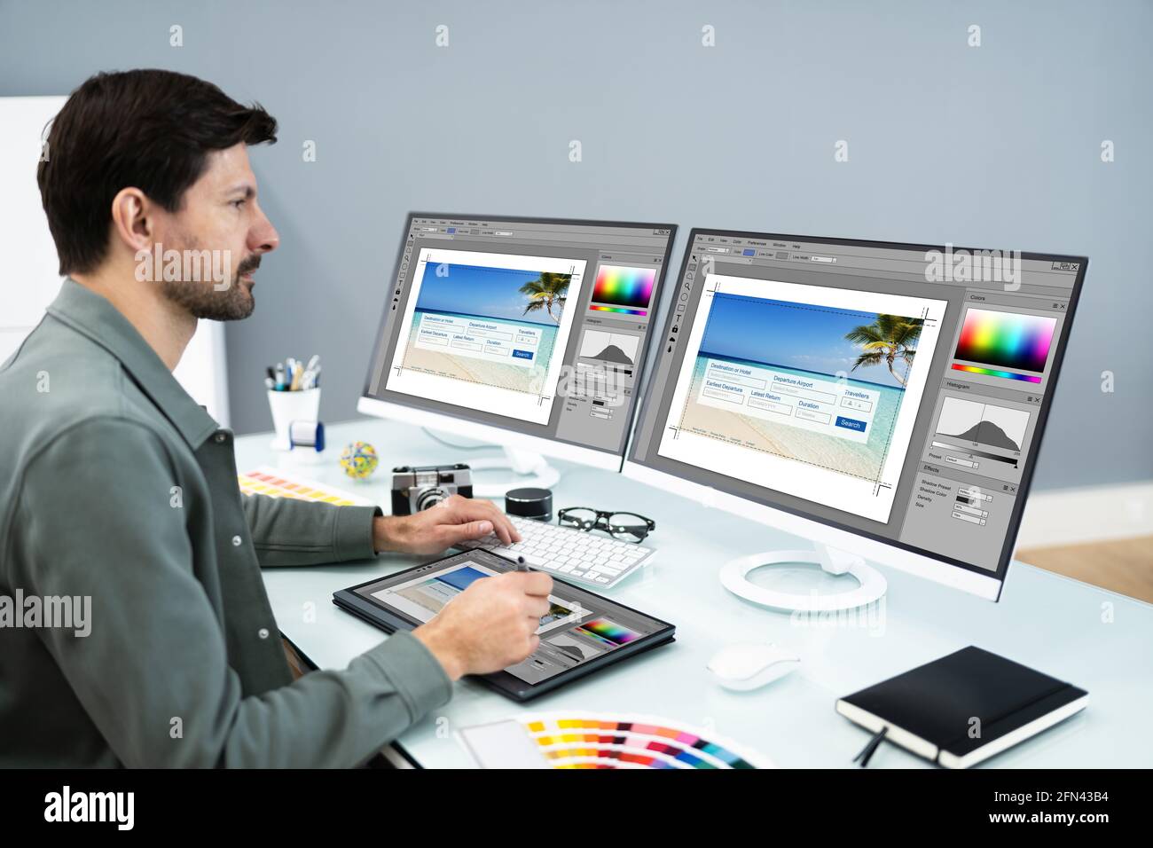 Designer And Photographer Using Multiple Computer Screens Stock Photo ...