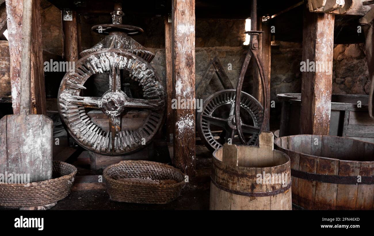 An ancient hand mill made of stones and wood. Flour grinding device ...