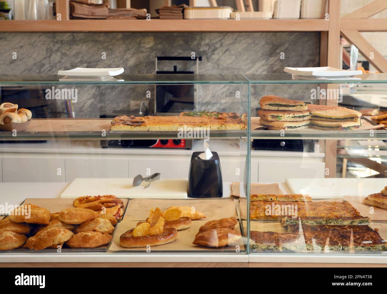 Elegant counter of a sandwich shop with Italian dishes on display ...