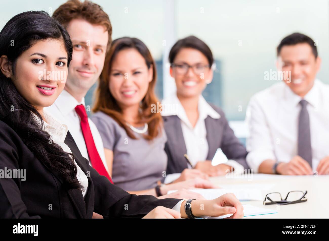 Asian Business Team in conference meeting looking at camera Stock Photo ...