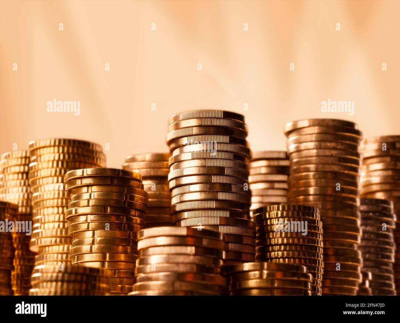 Many stacks of red gold coins Stock Photo - Alamy