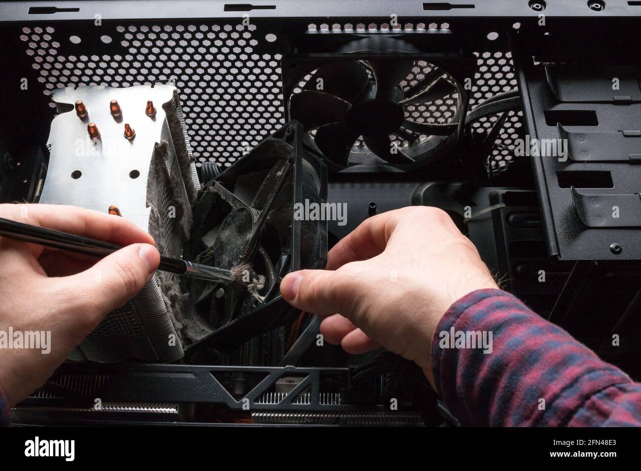 computer technician cleans the CPU cooler and hardware Stock Photo - Alamy