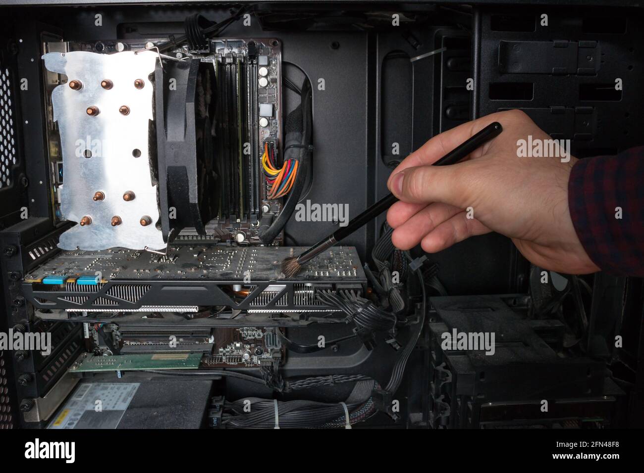 electronic computer technology engineer cleans the PC hardware from ...