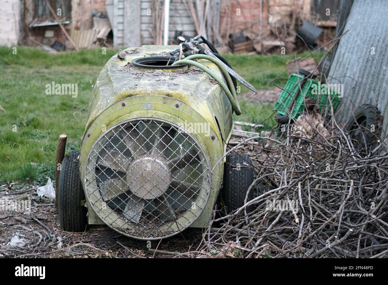 Old agricultural tools abandoned in the garden. Broken agricultural ...