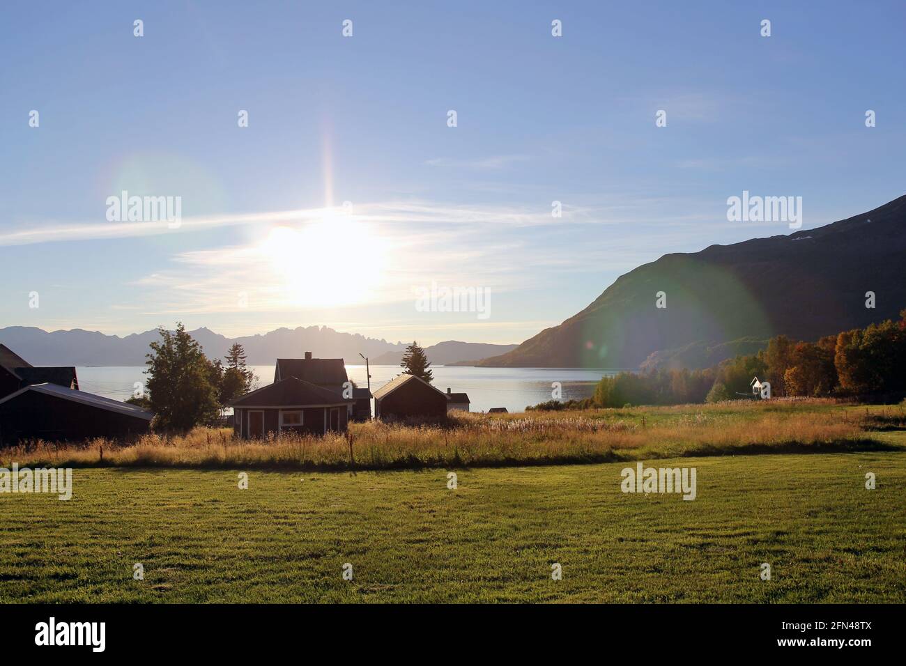 Sunset over a Norwegian fjord. Landscape with Norwegian alps and little ...