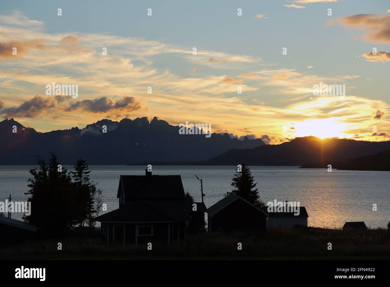 Sunset over a Norwegian fjord. Landscape with Norwegian alps and little ...
