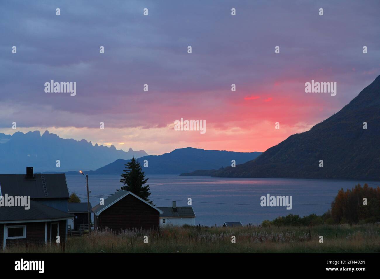 Sunset over a Norwegian fjord. Landscape with Norwegian alps and little ...