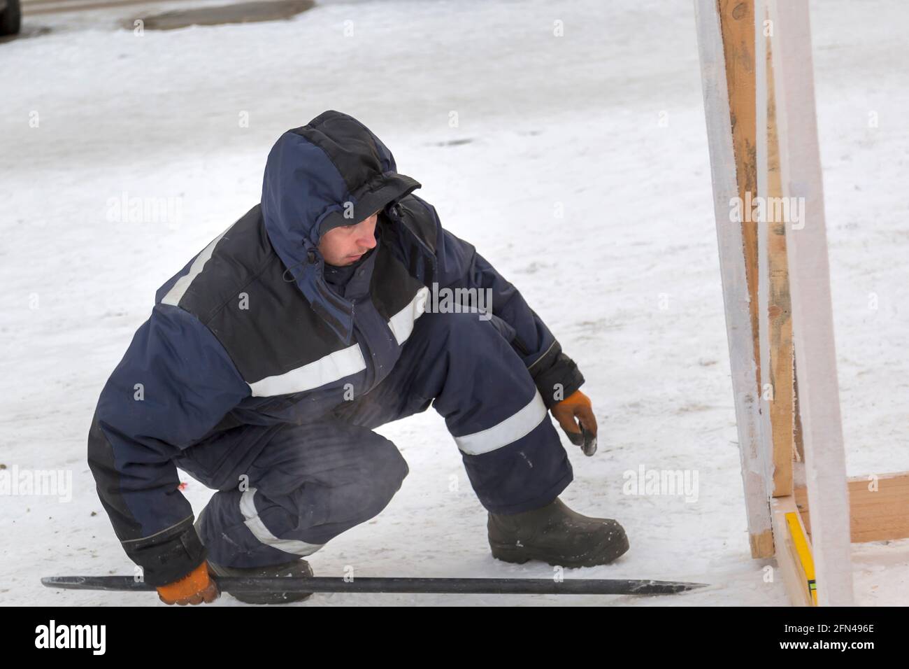 Worker on timber frame construction with crowbar in hand Stock Photo ...
