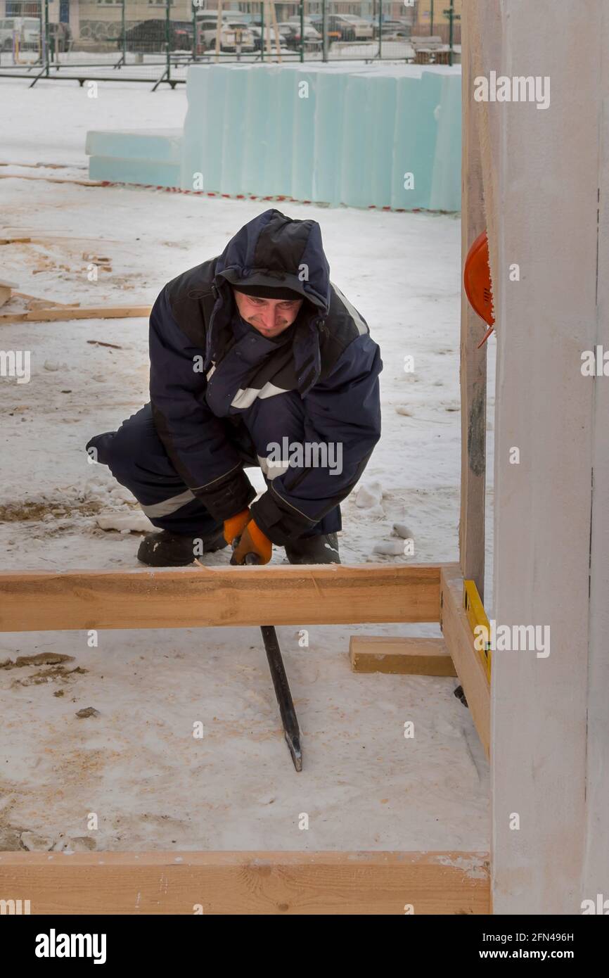 Worker on timber frame construction with crowbar in hand Stock Photo ...