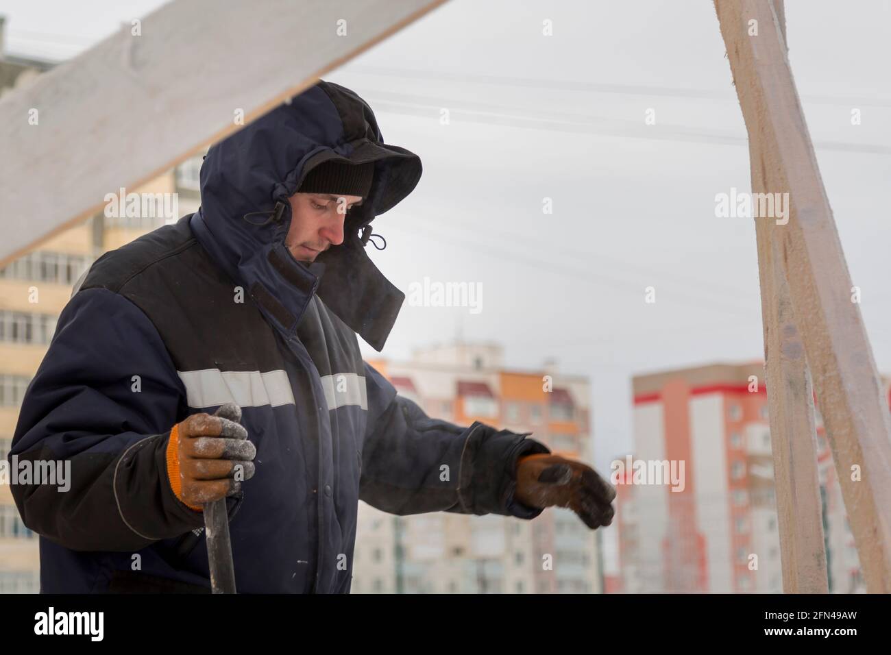 Worker on timber frame construction with crowbar in hand Stock Photo ...