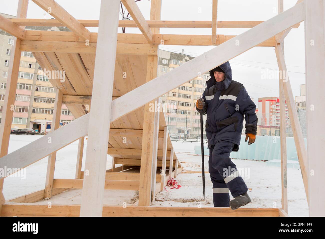 Worker on timber frame construction with crowbar in hand Stock Photo ...