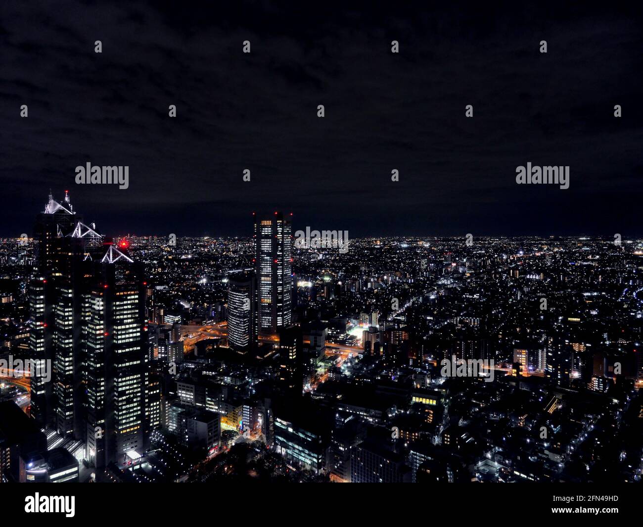 Stunning Tokyo landscape by night under a cloudy sky, modern ...