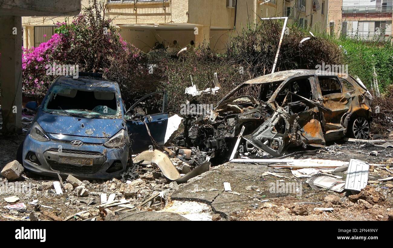 Damaged cars in a residential building hit by a rocket fired from the ...