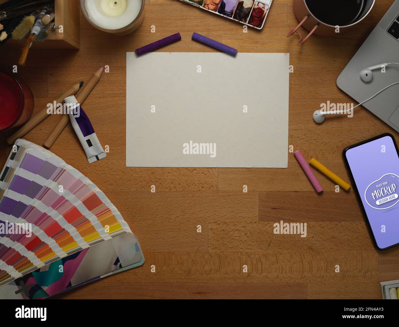 Top view of artist workspace with blank paper, paint tools, mock up ...
